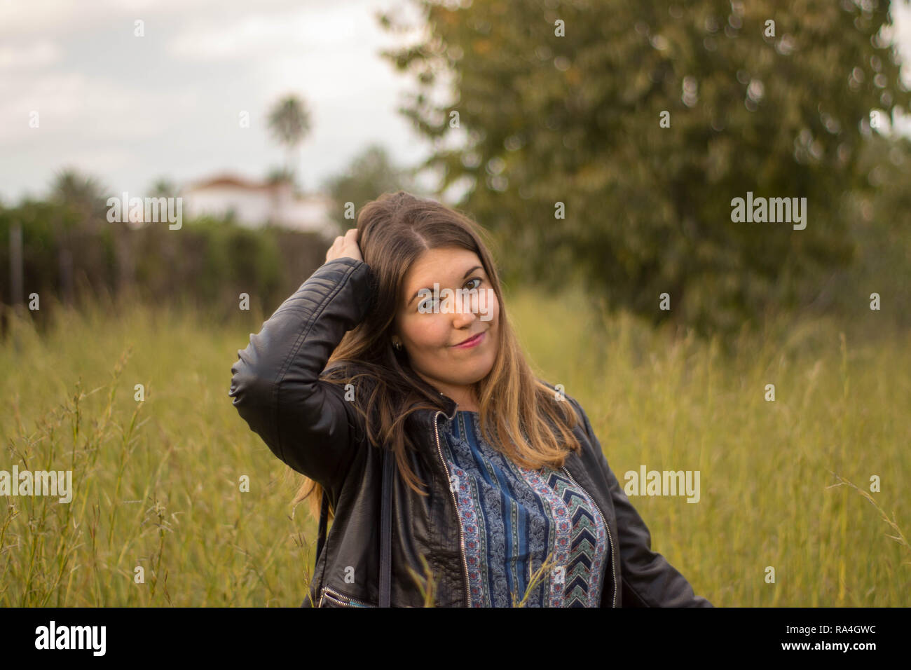 beautiful model with black jacket on outside forest background Stock ...
