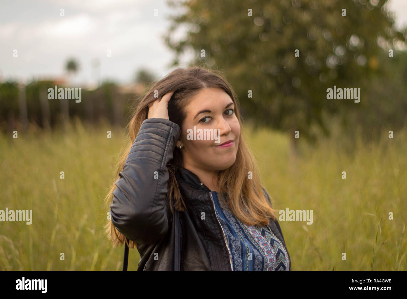 beautiful model with black jacket on outside forest background Stock ...