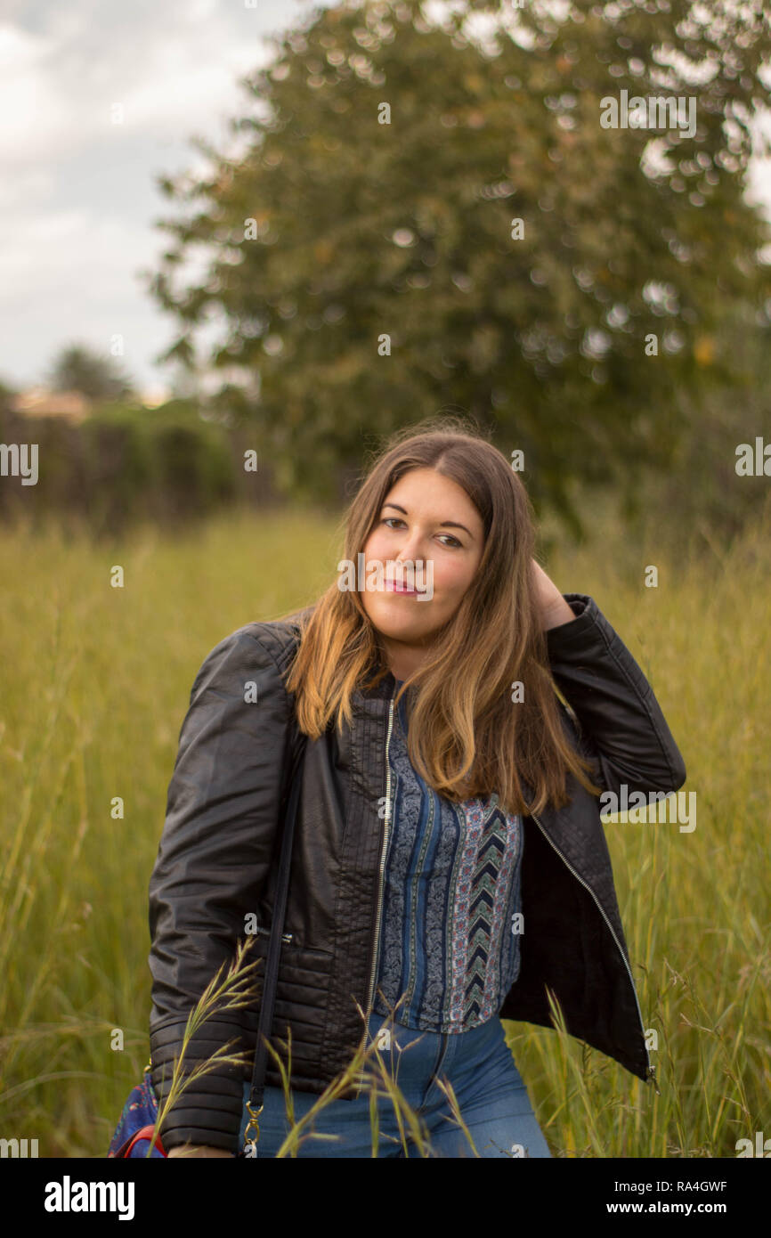 beautiful model with black jacket on outside forest background Stock ...