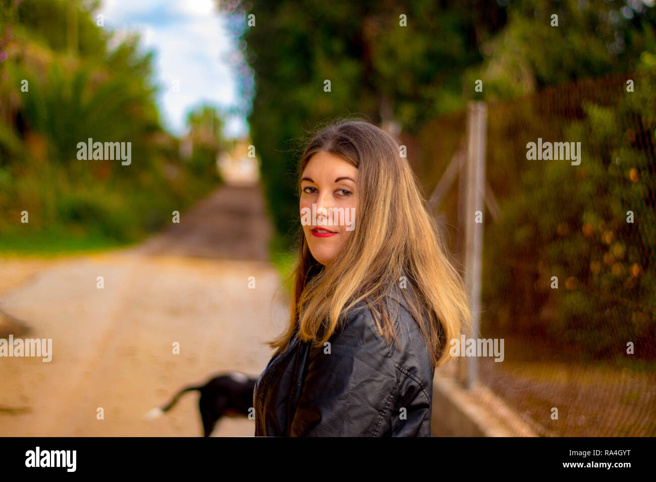 beautiful model with black jacket on outside forest background Stock ...
