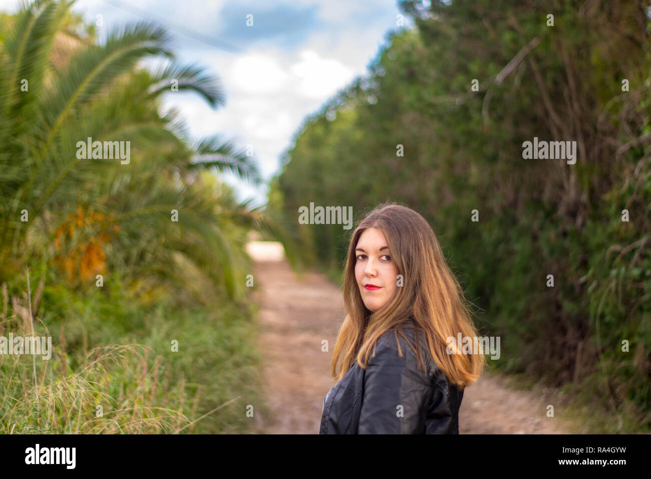 beautiful model with black jacket on outside forest background Stock ...