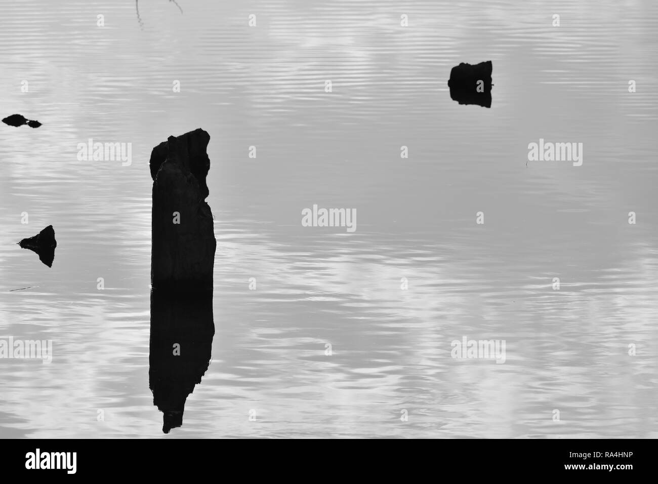 Shadow of object forming on water during sunset Stock Photo - Alamy