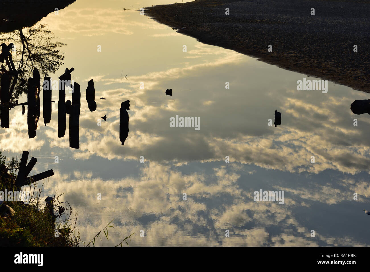 Shadow of object forming on water during sunset Stock Photo - Alamy