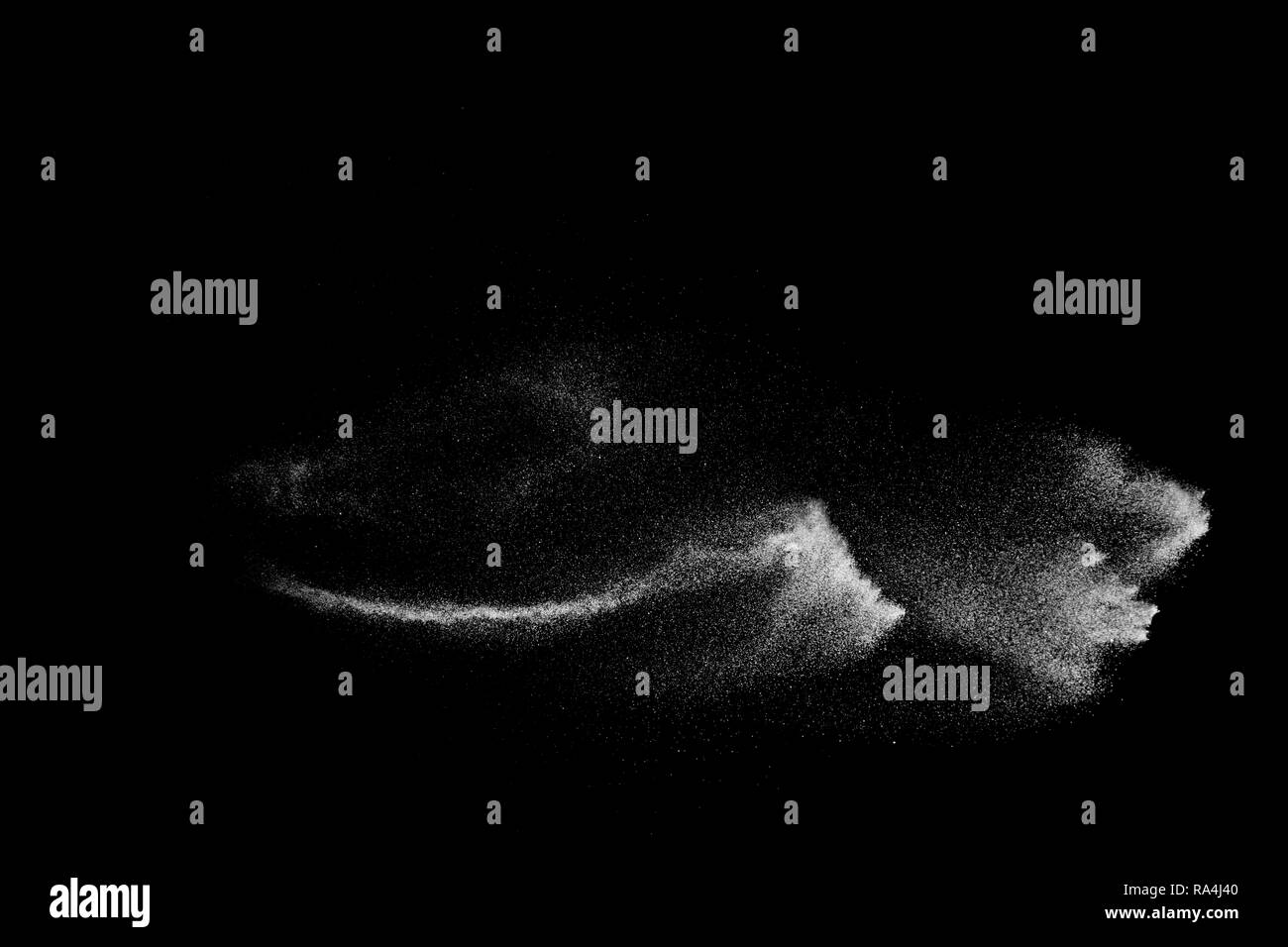 White particles splash on black background. White dust splatter on dark ...