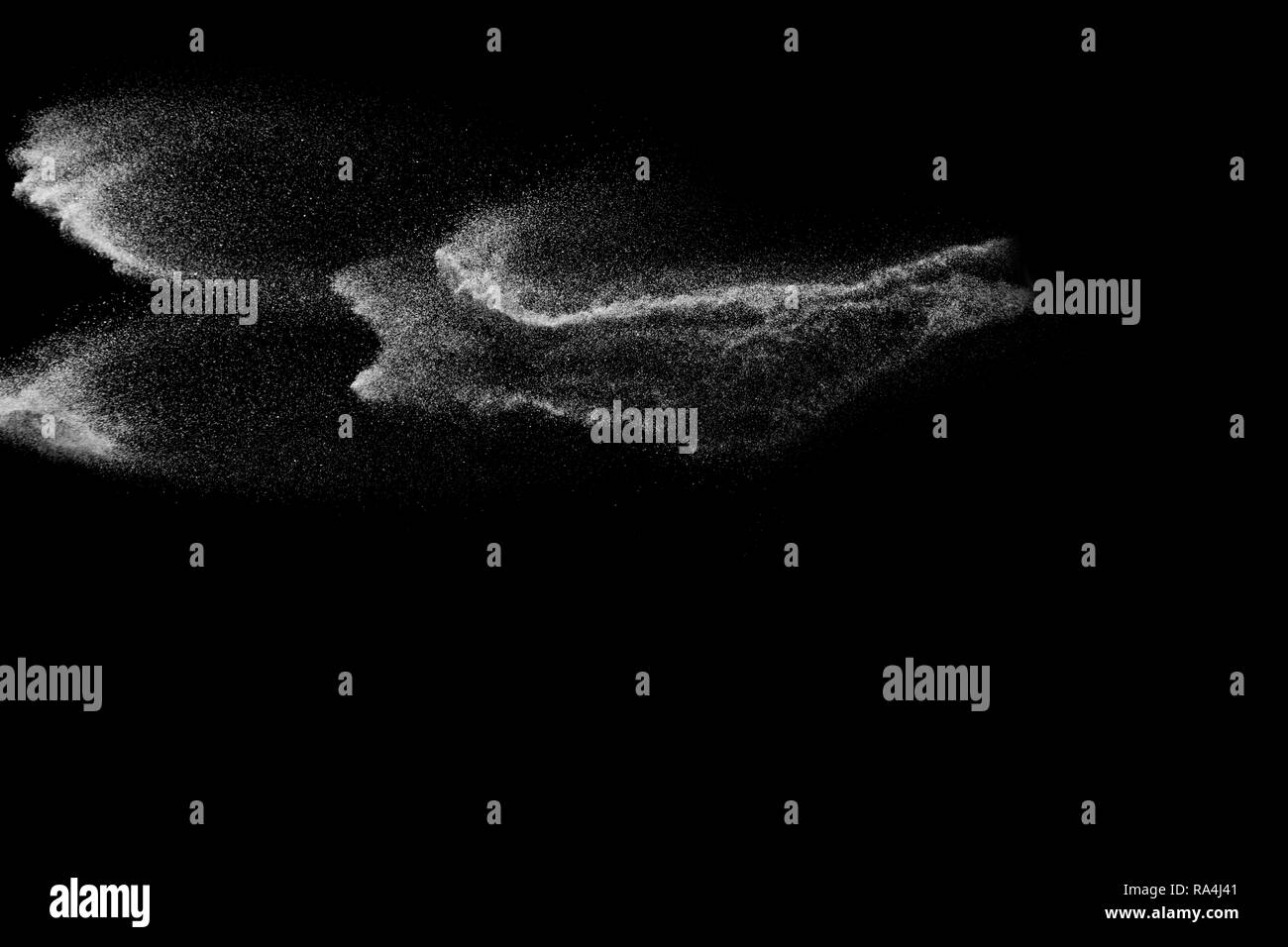 White particles splash on black background. White dust splatter on dark ...