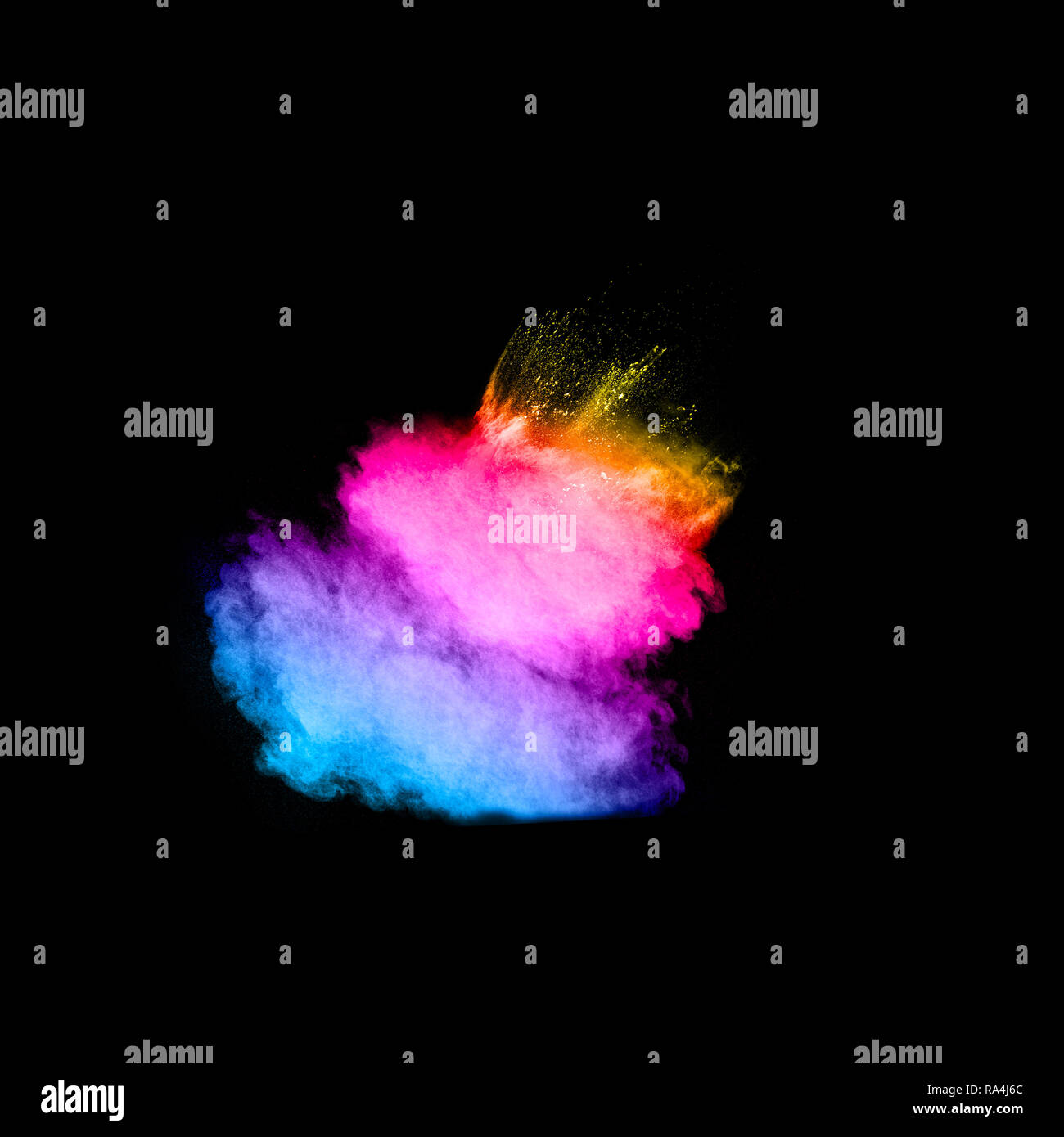 Multicolored powder explosion cloud isolated on black background ...