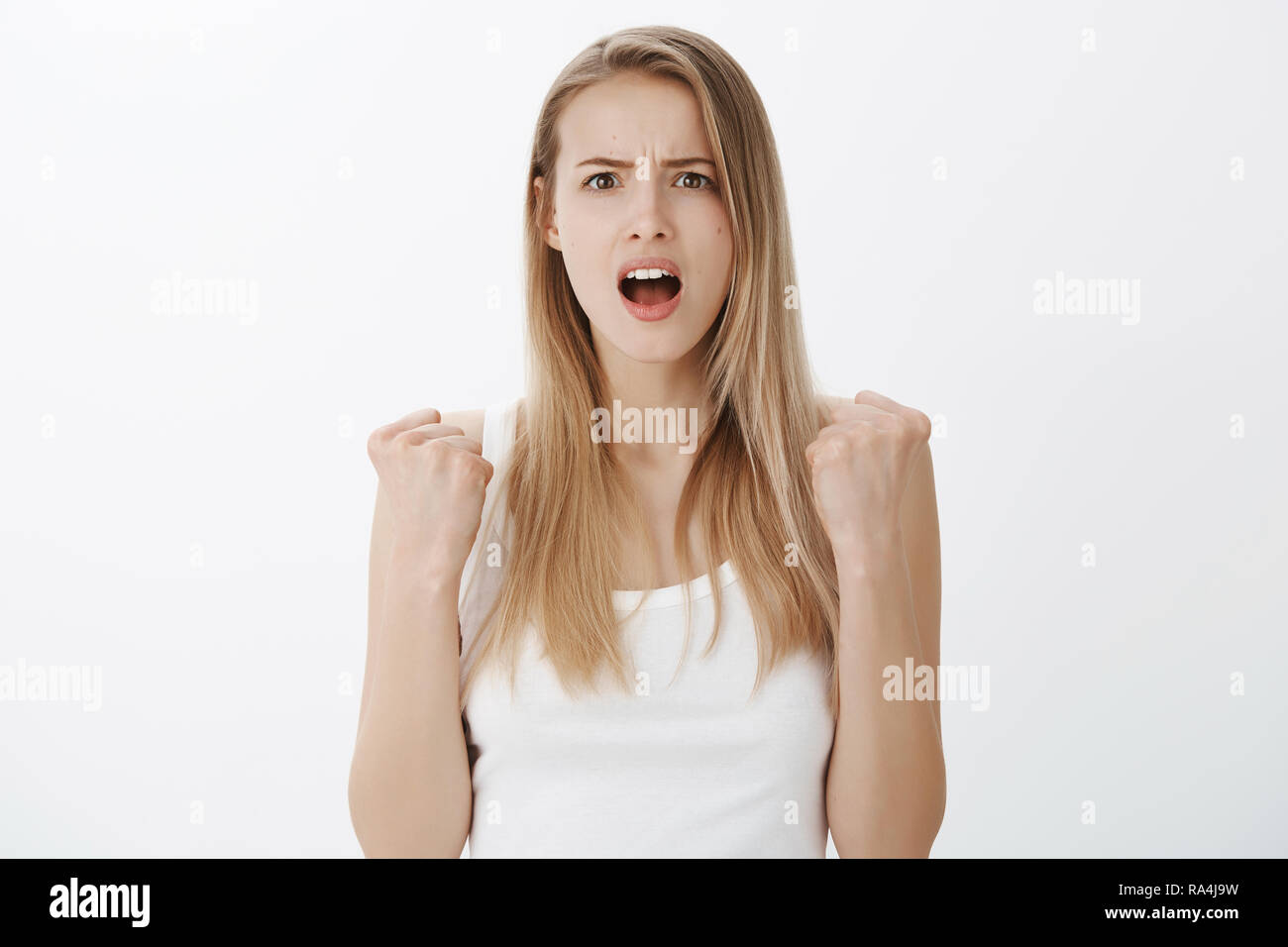 Studio shot of woman realising she lost being shocked and devestated as ...
