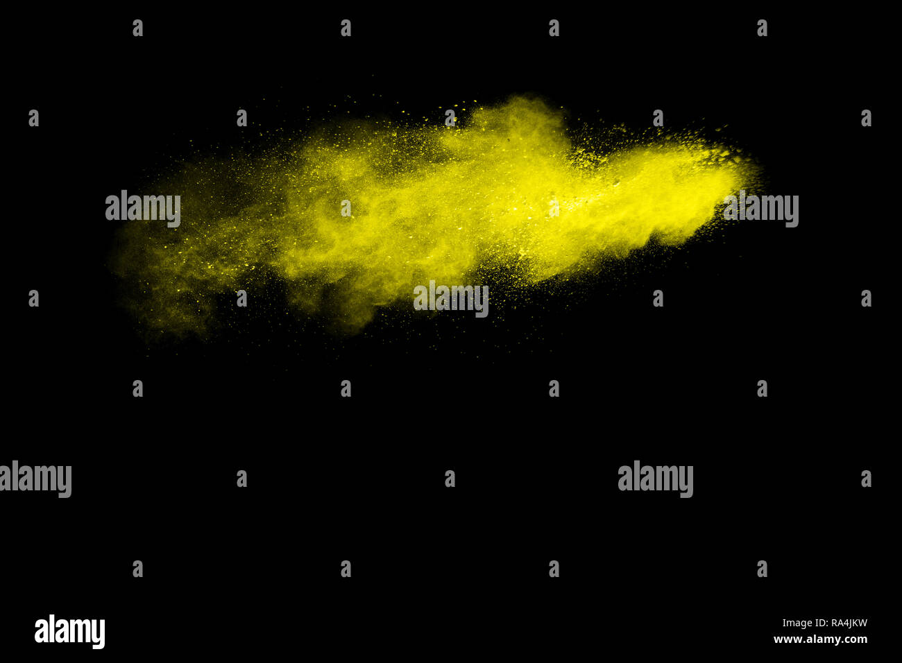 Yellow color powder explosion cloud on black background Stock Photo - Alamy