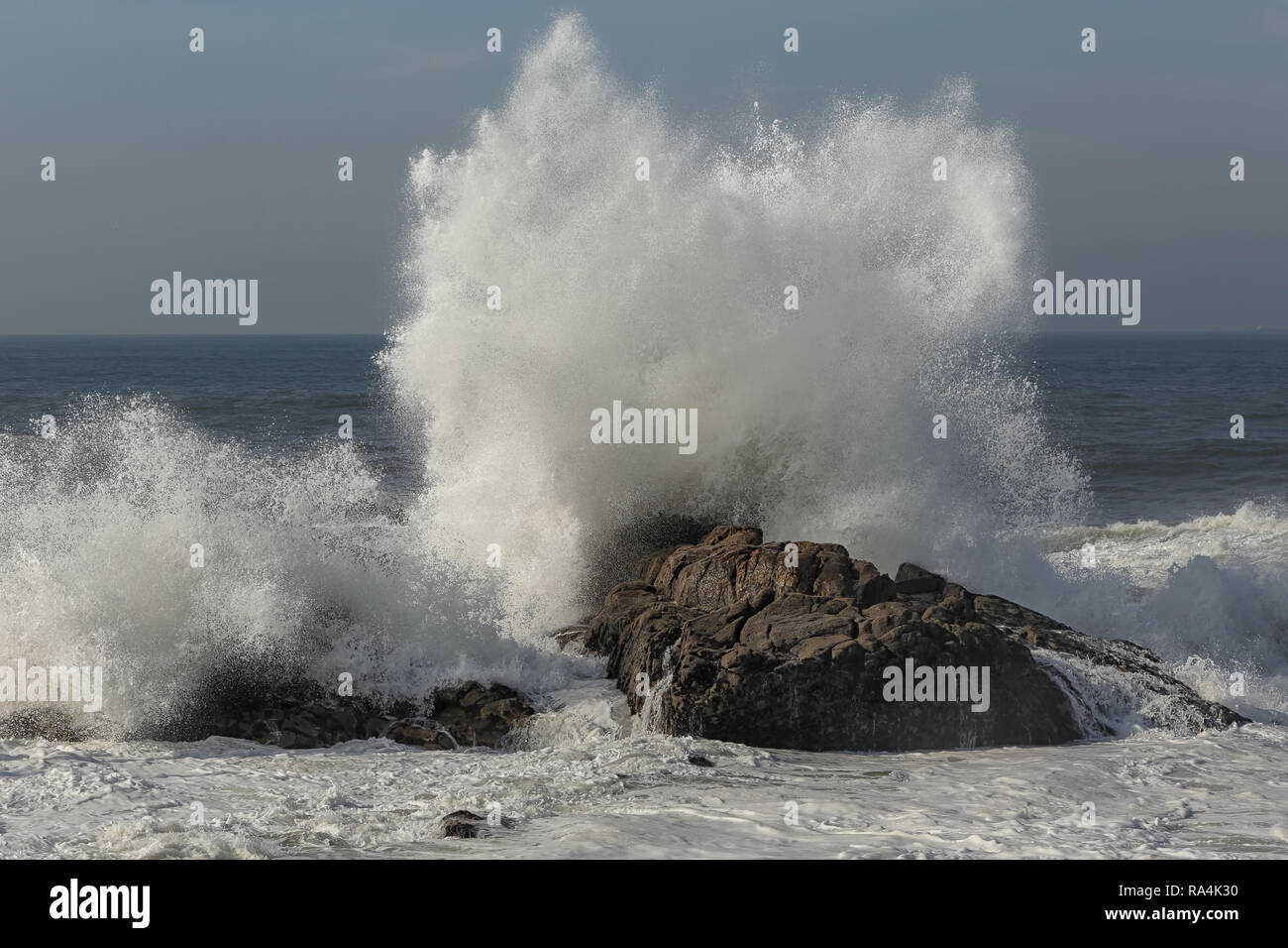 Detailed big splash from waves against beach rocks. North of Portugal ...