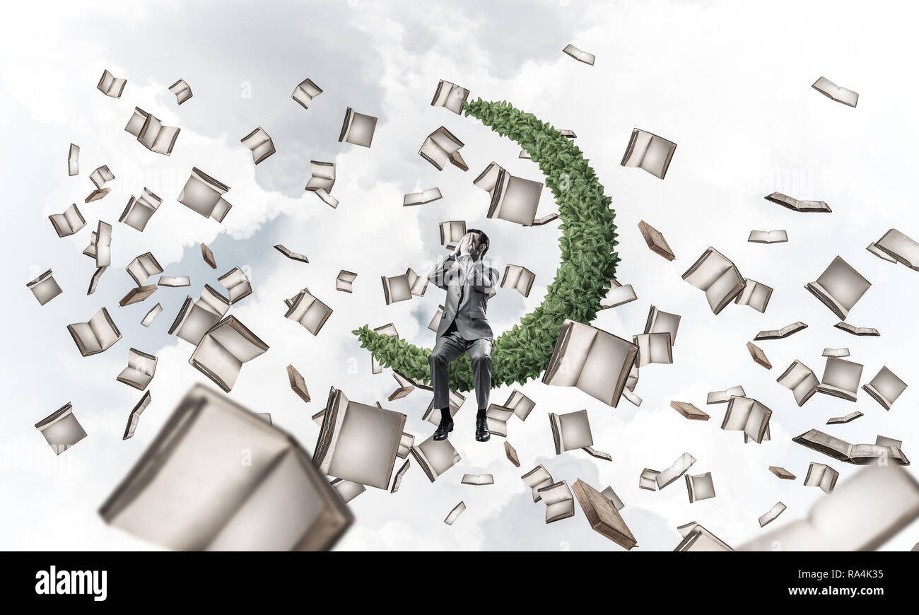 Young man in sky do not want to see anything and books flying ar Stock ...