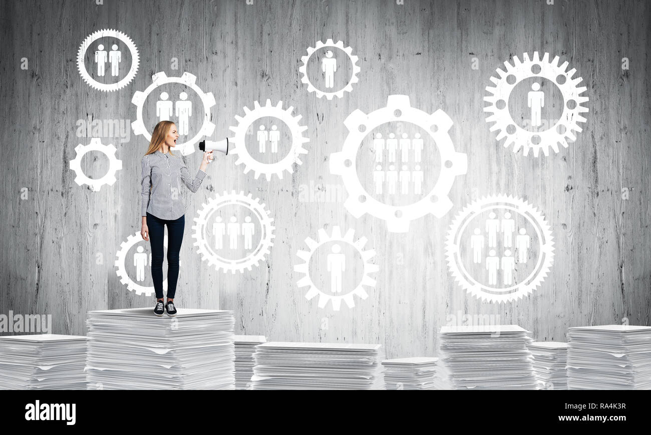 Woman standing with megaphone Stock Photo - Alamy