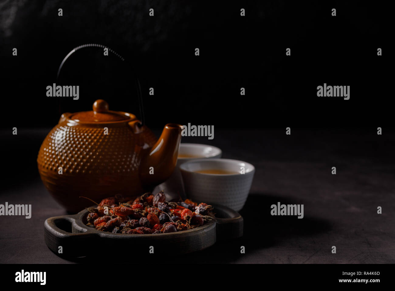Tea ceremony. The process of brewing tea. Teapot and cups with freshly ...