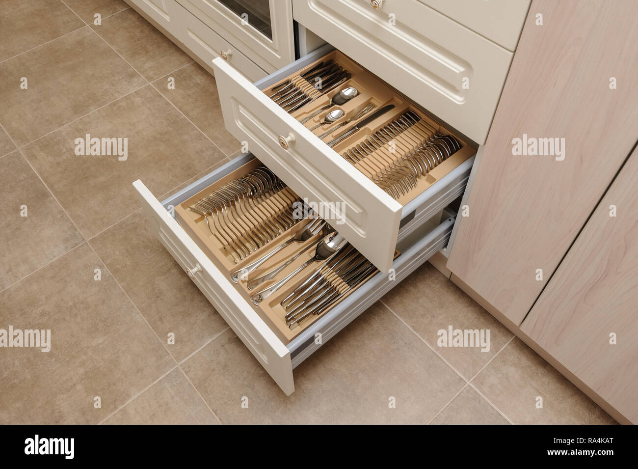 Opened kitchen drawers with silverware Stock Photo - Alamy