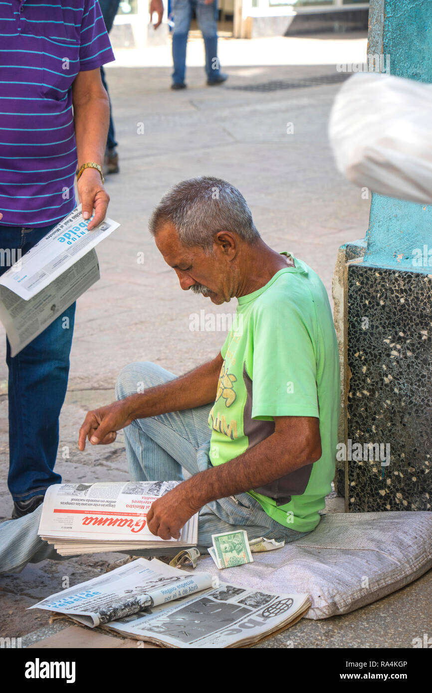 cuban man sells newspapers in a street in Havana Cuba Caribbean Stock ...
