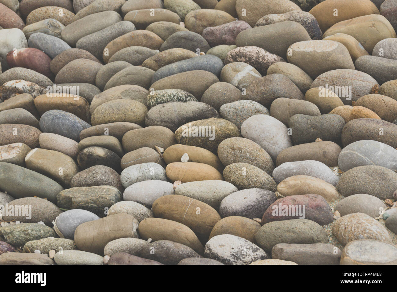 Photograph of a rounded river rocks background Stock Photo - Alamy