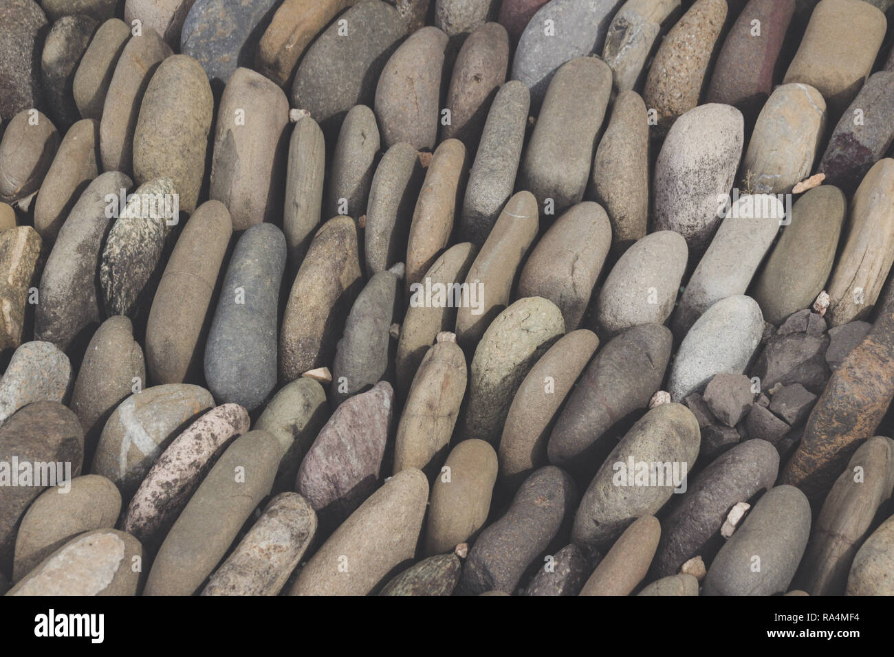 Photograph of a rounded river rocks background Stock Photo - Alamy
