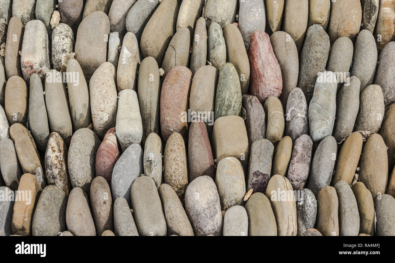 Photograph of a rounded river rocks background Stock Photo - Alamy