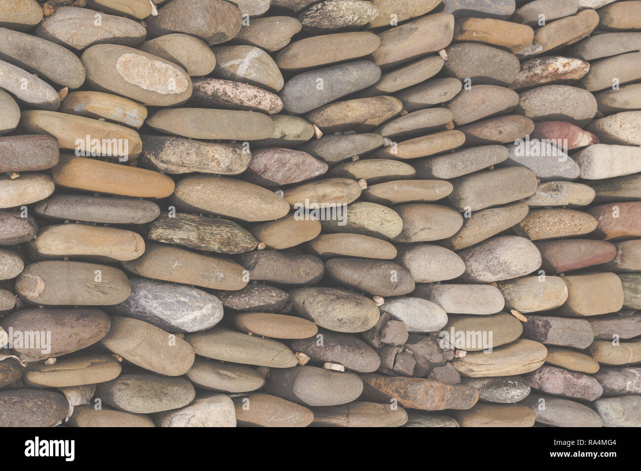 Photograph of a rounded river rocks background Stock Photo - Alamy
