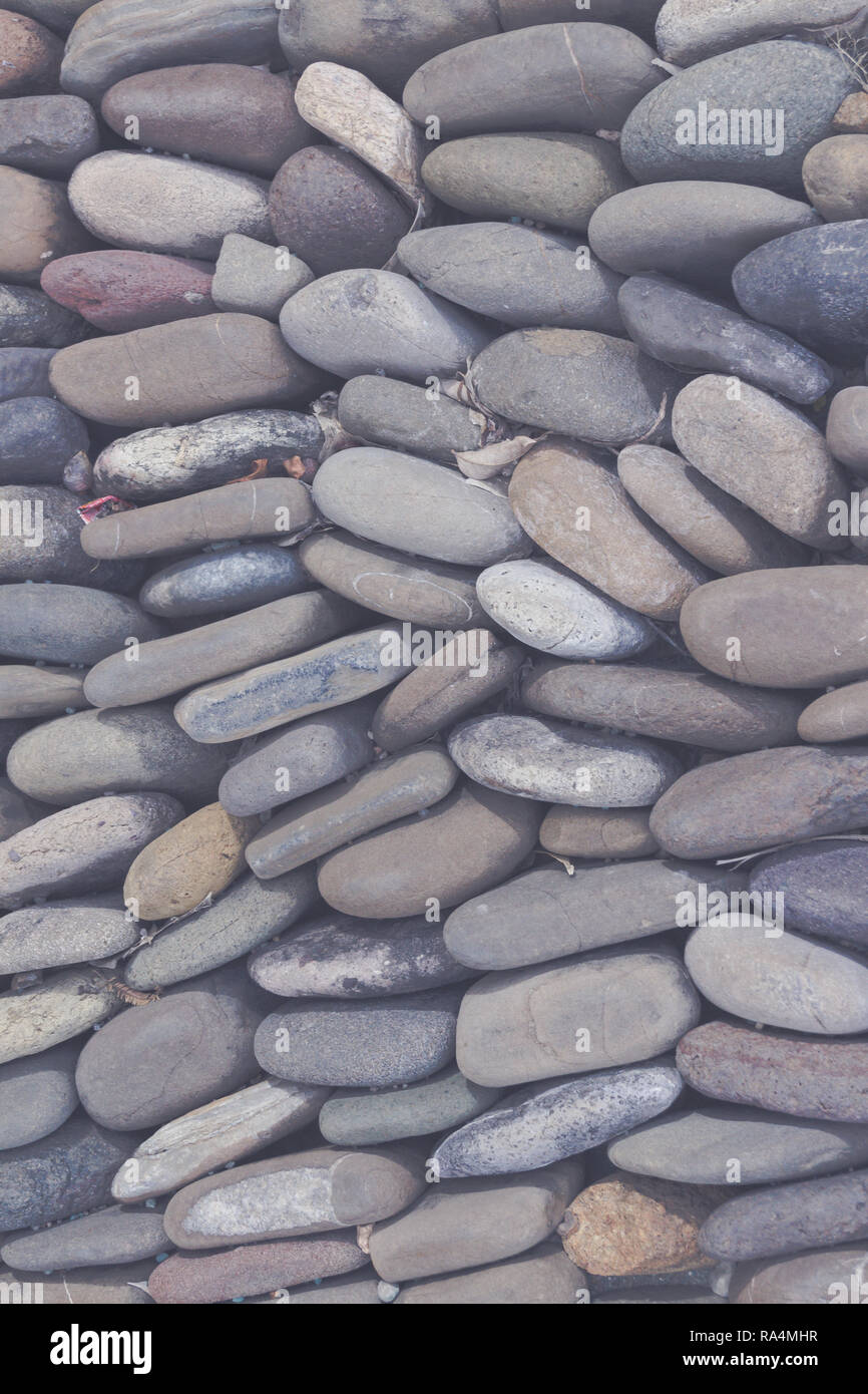 Photograph of a rounded river rocks background Stock Photo - Alamy