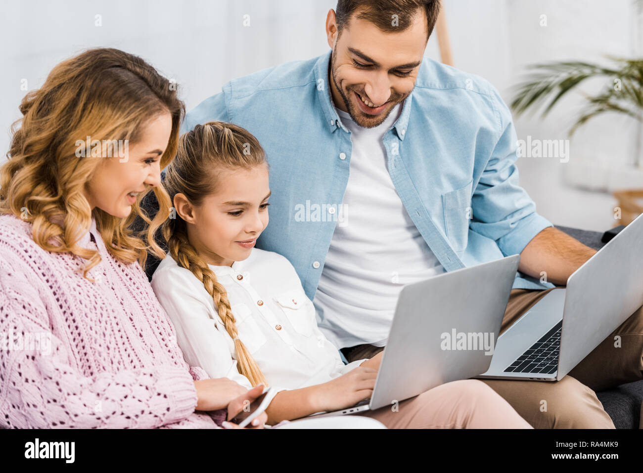 Smiling parents sitting on hi-res stock photography and images - Alamy