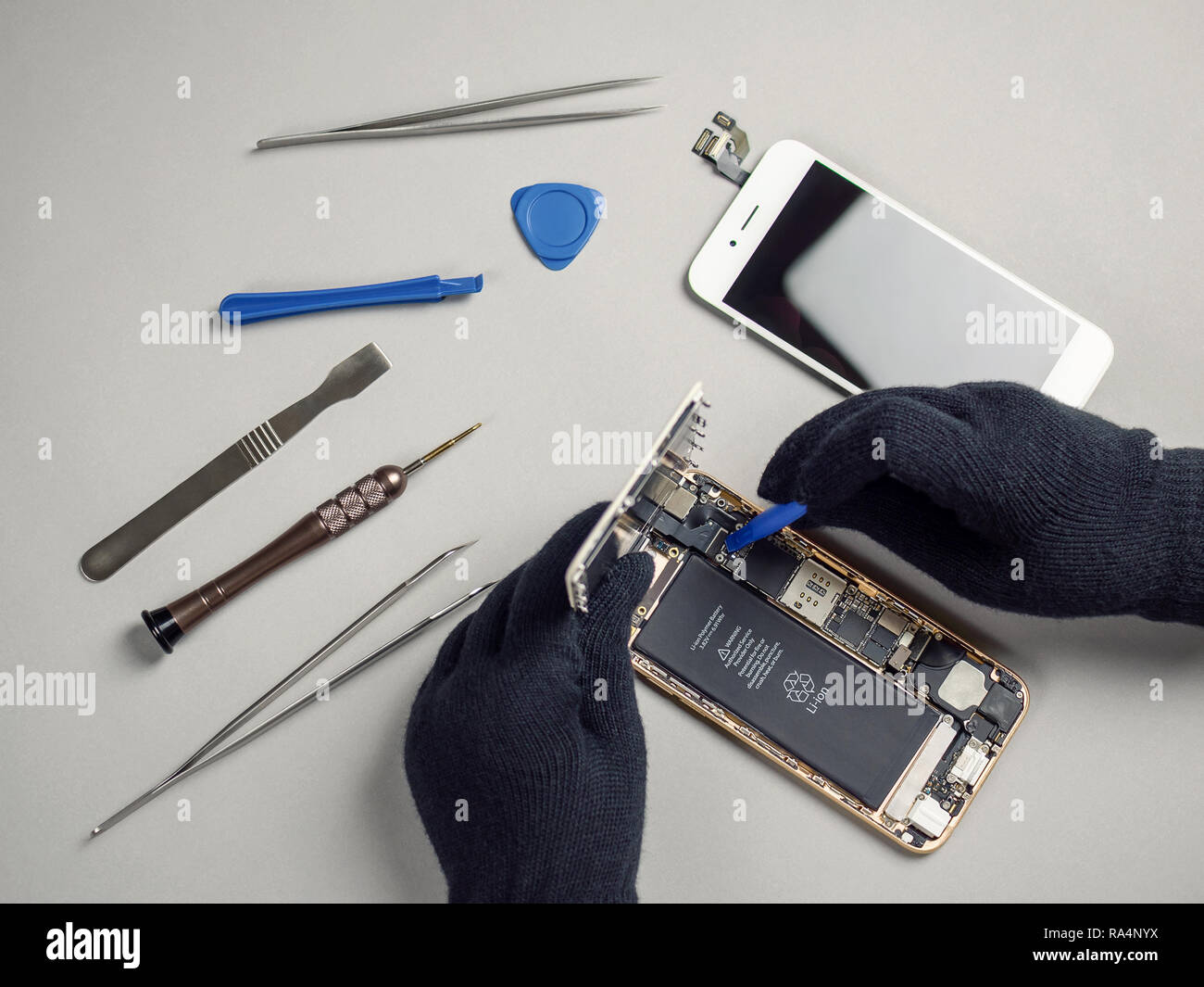 Technician or engineer disassembling components broken smartphone for ...