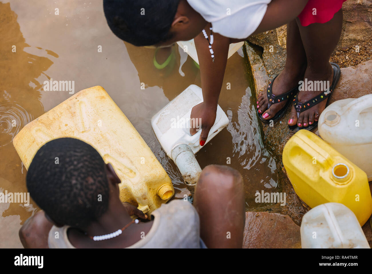 Children carrying water cans in Uganda, Africa Stock Photo - Alamy