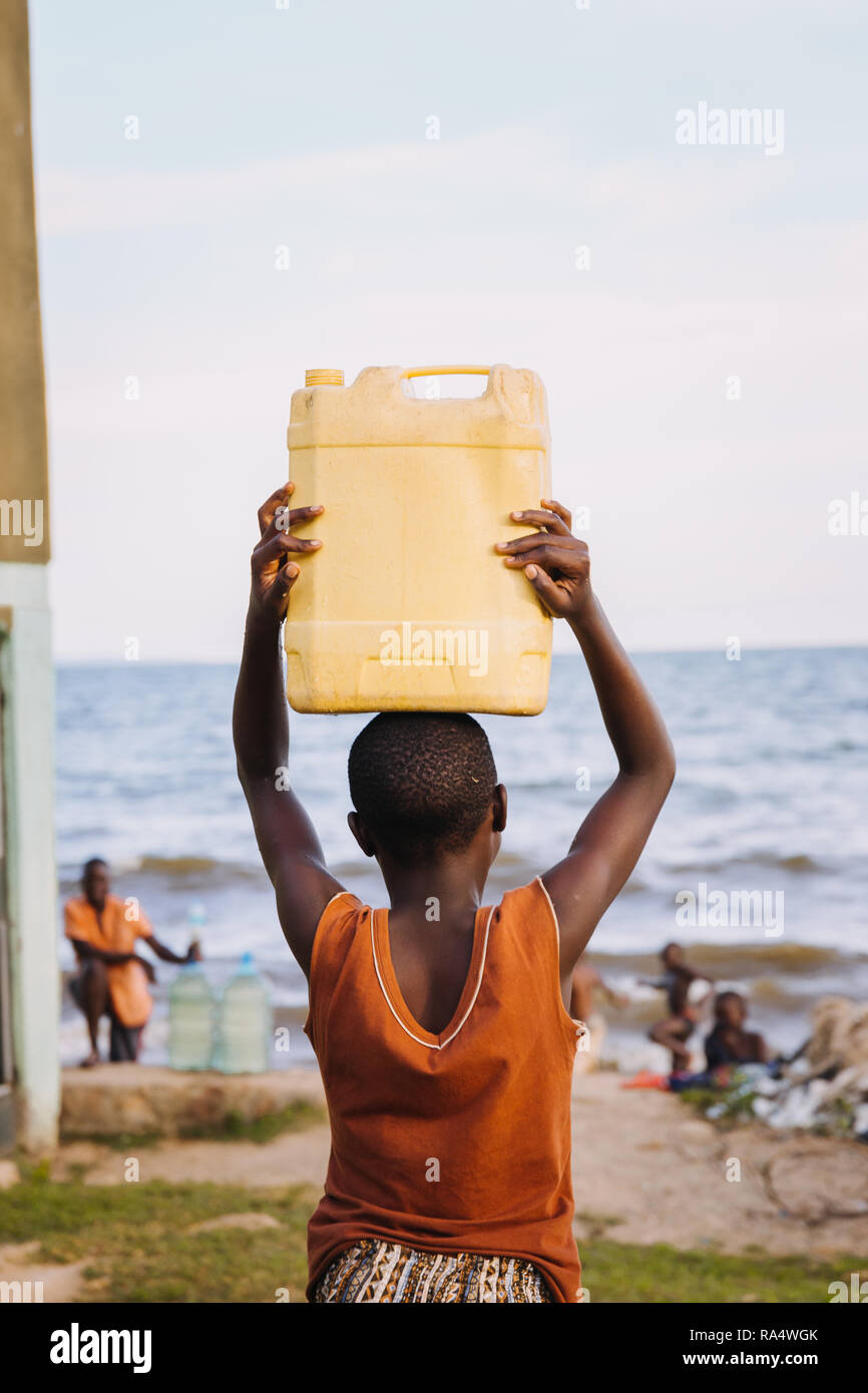 Child carrying water in Uganda, Africa Stock Photo - Alamy