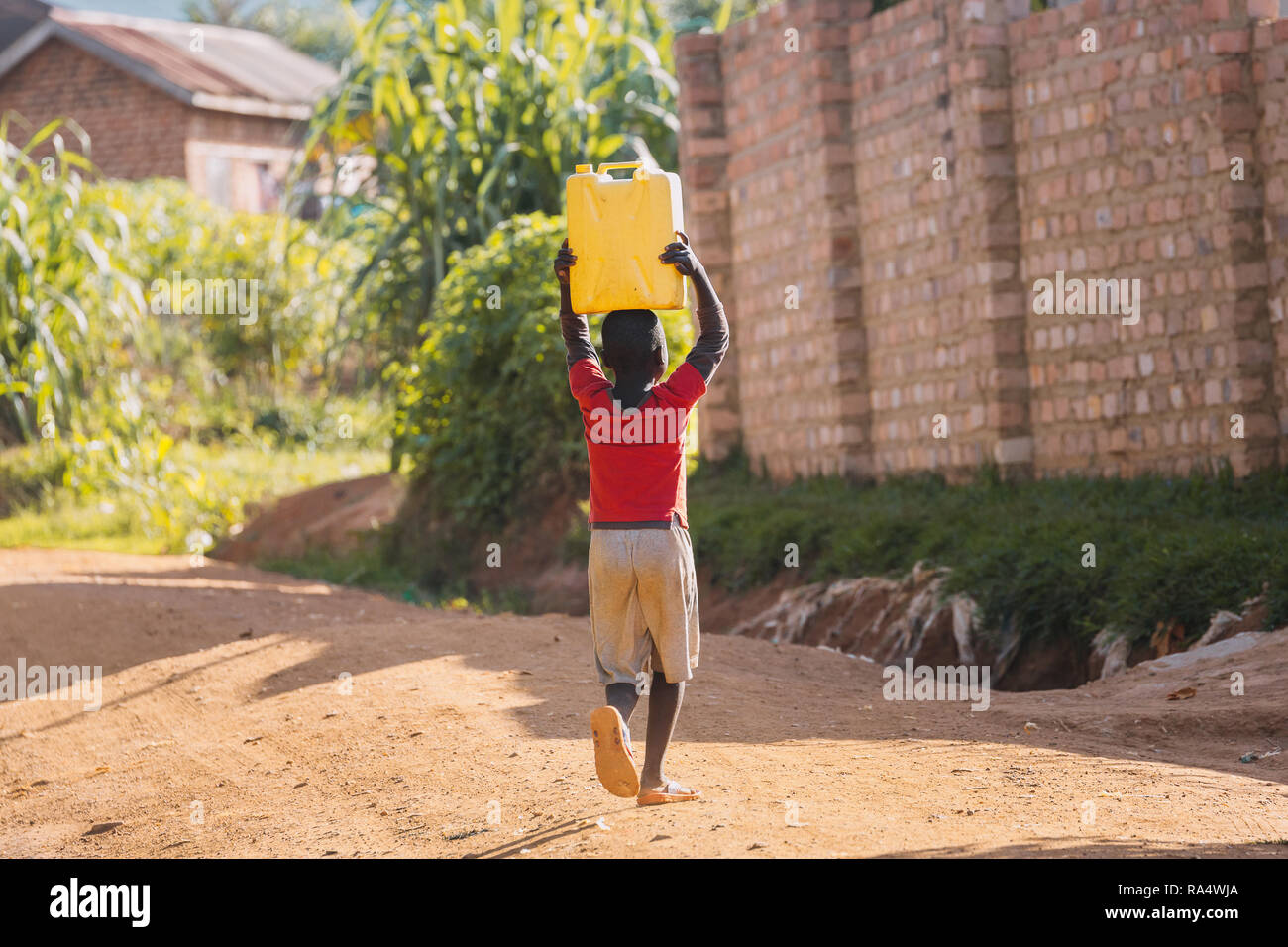 Child carrying water in Uganda, Africa Stock Photo - Alamy