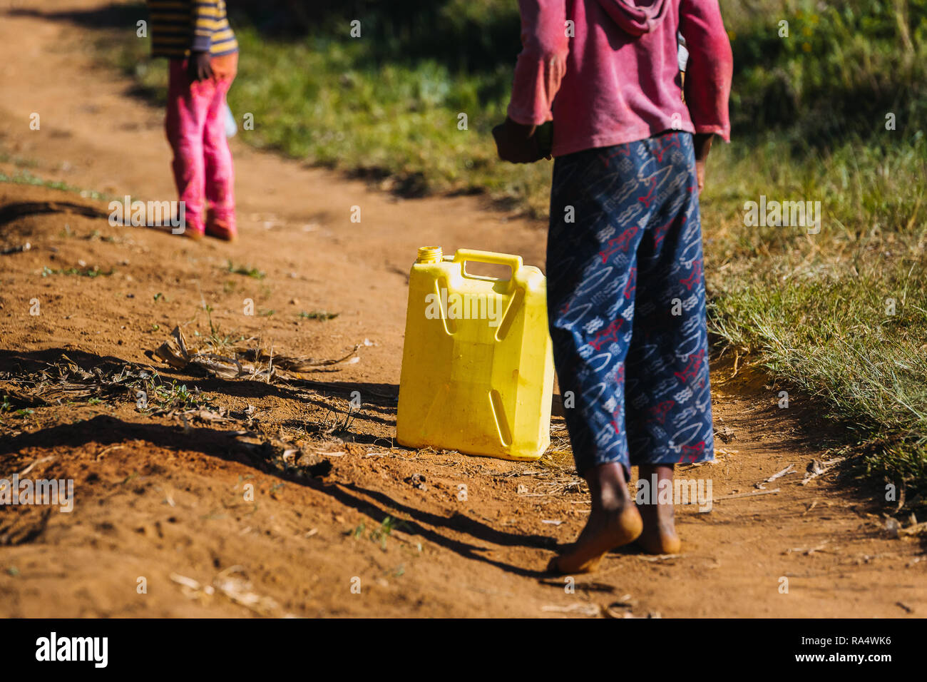 Children carrying water cans in Uganda, Africa Stock Photo - Alamy