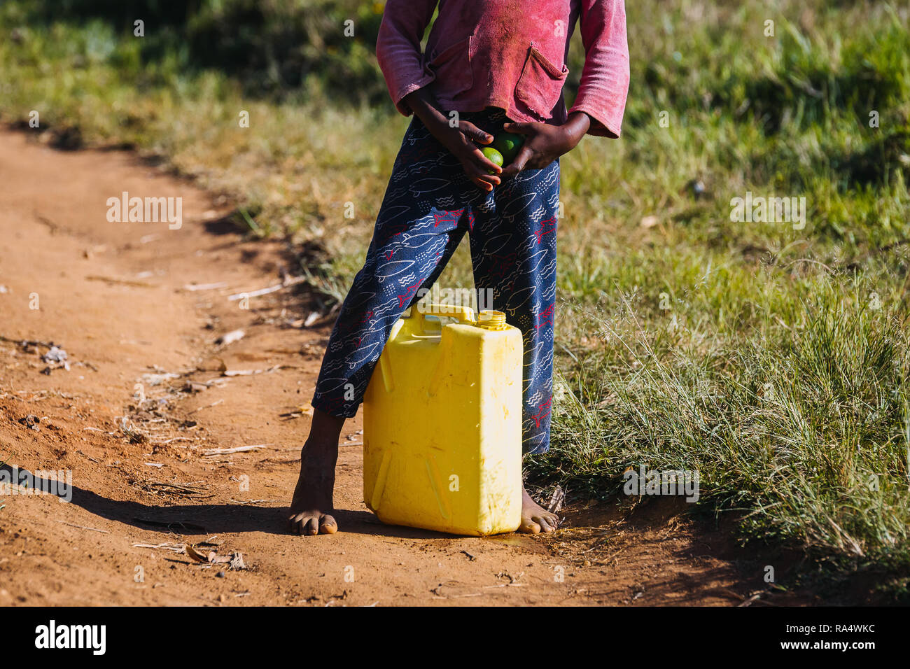 Children carrying water cans in Uganda, Africa Stock Photo - Alamy