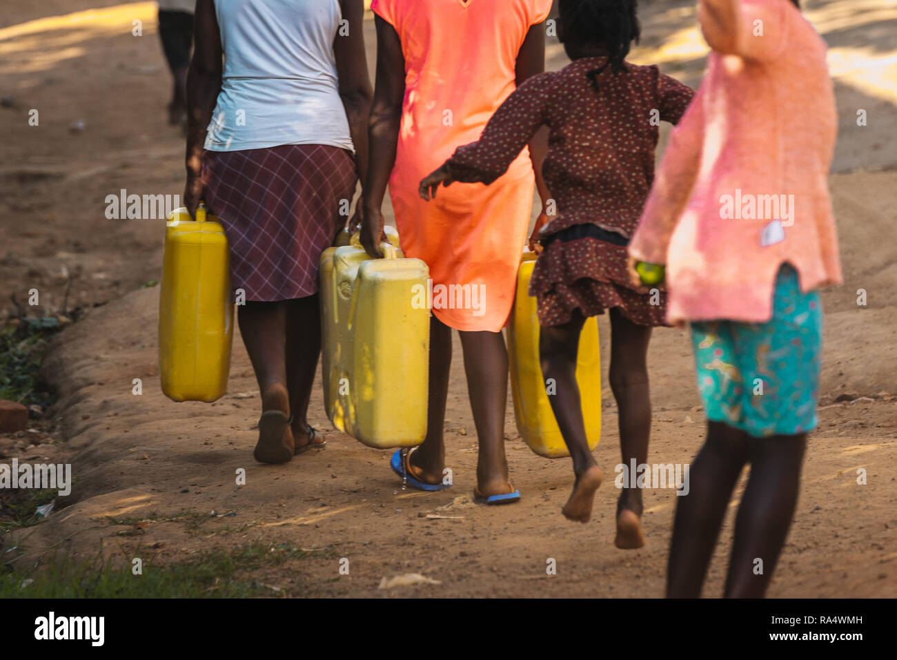 Child carrying water in Uganda, Africa Stock Photo - Alamy