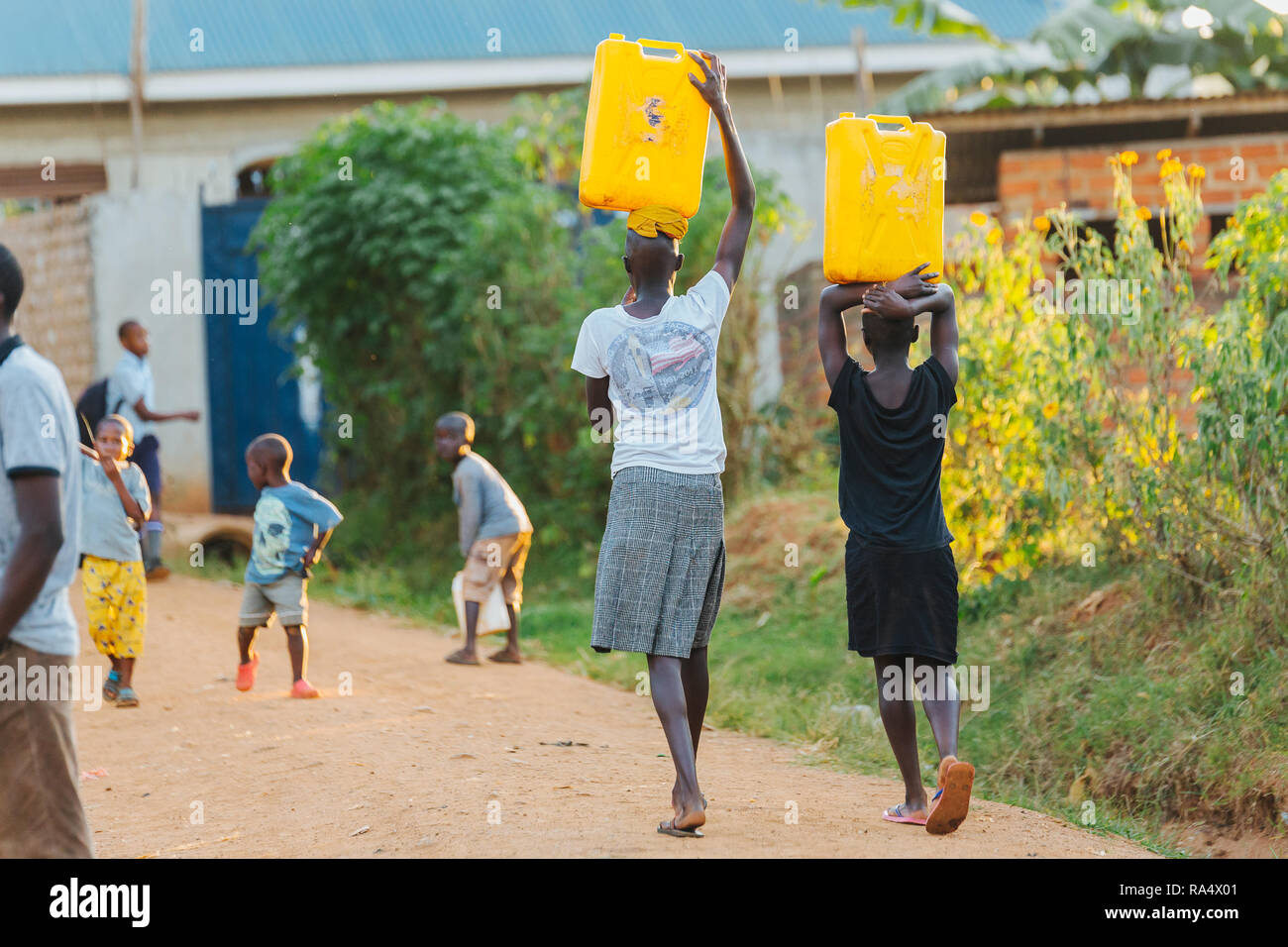 Child carrying water in Uganda, Africa Stock Photo - Alamy
