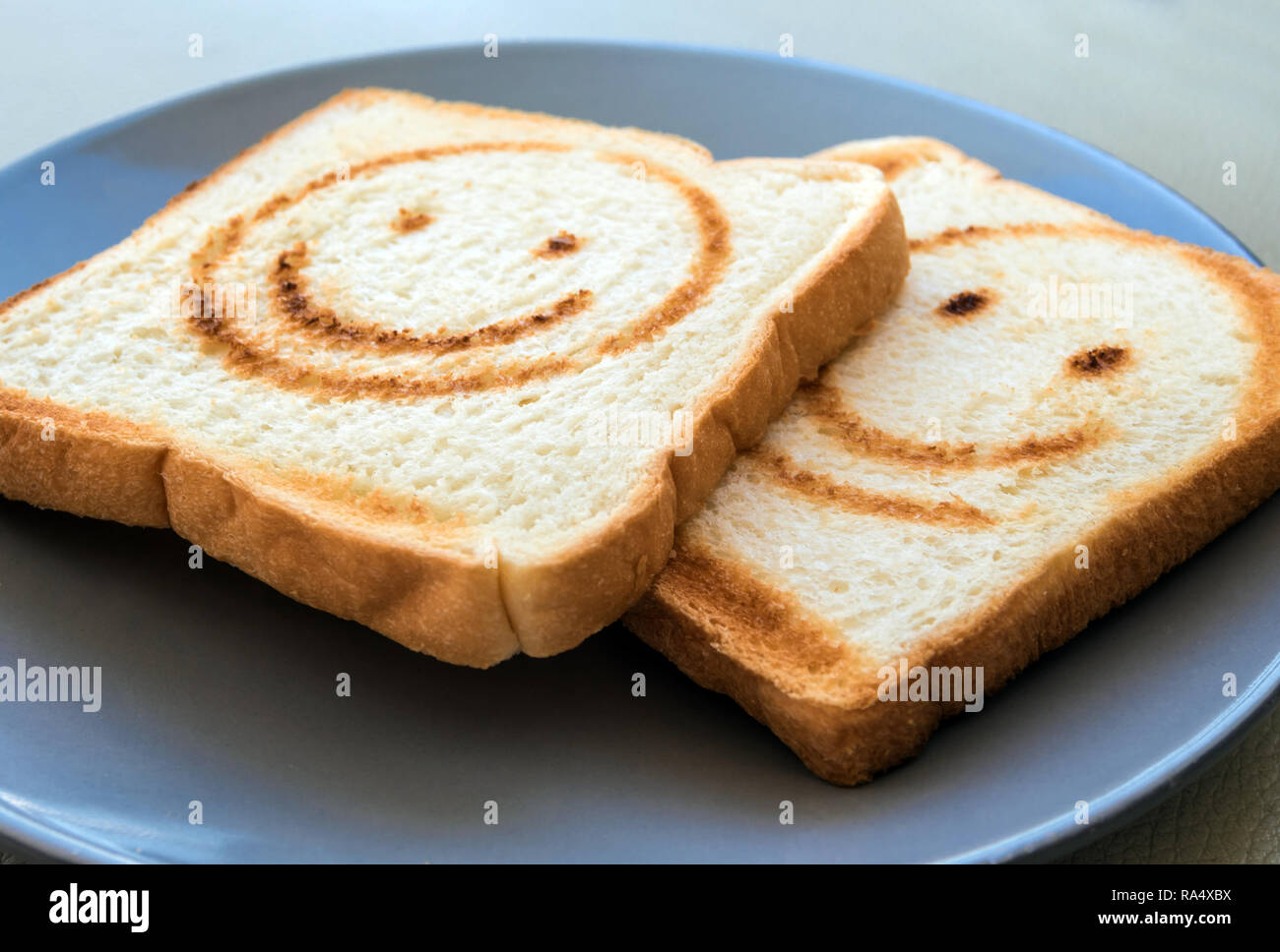 Burning line as happy face on the bread sheet Stock Photo - Alamy