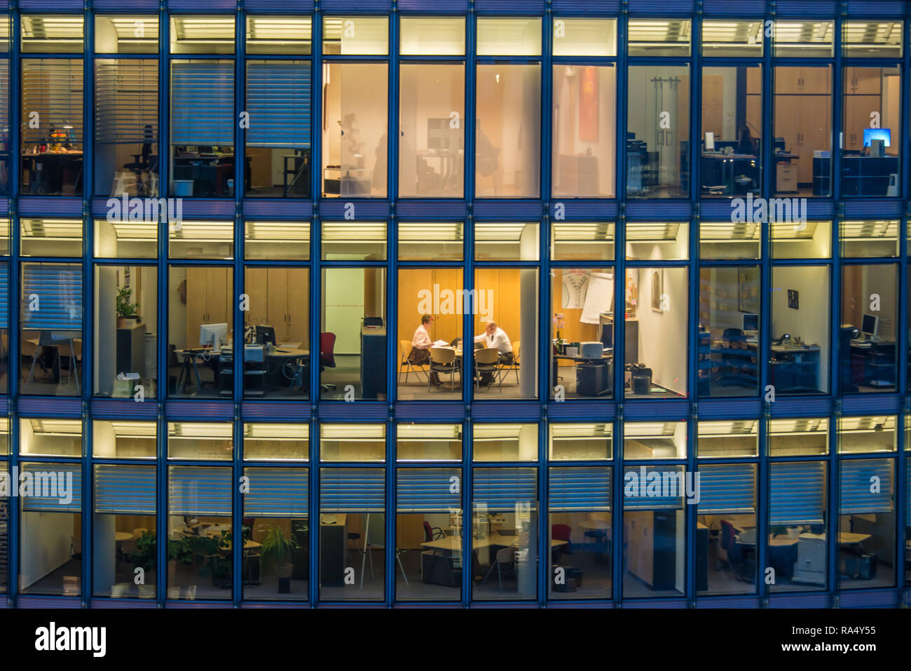 skyscraper Office windows and office worker by night square pattern ...
