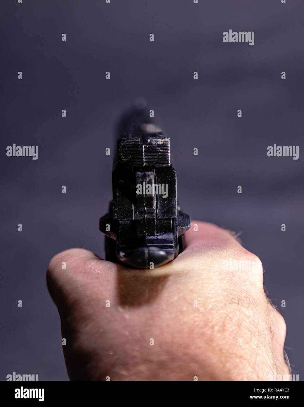 POV of hand aiming hand gun Stock Photo - Alamy