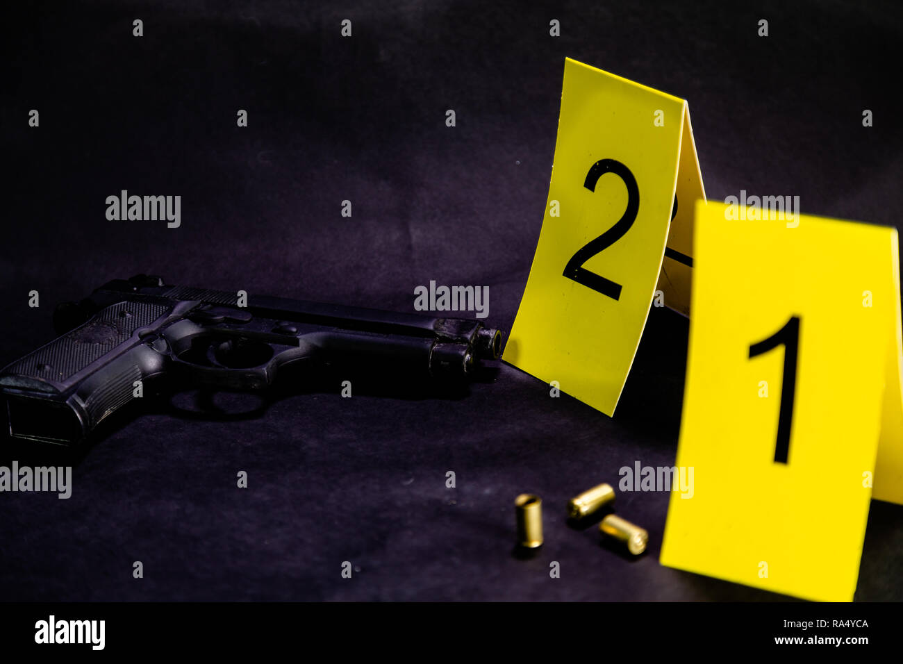 Bullets and gun next to markers at crime scene Stock Photo - Alamy