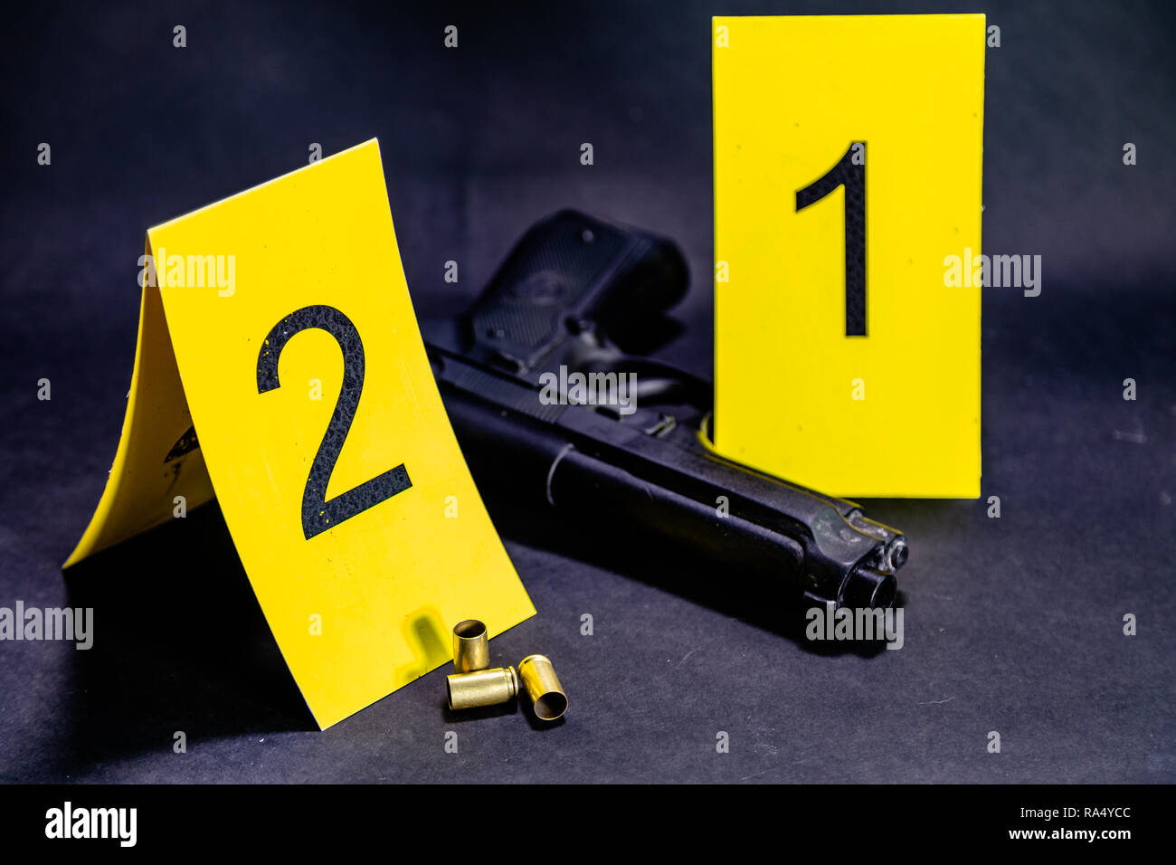 Bullets and gun next to markers at crime scene Stock Photo - Alamy