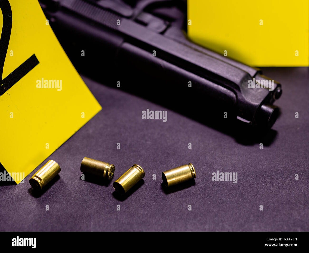 Bullets and gun next to markers at crime scene Stock Photo - Alamy