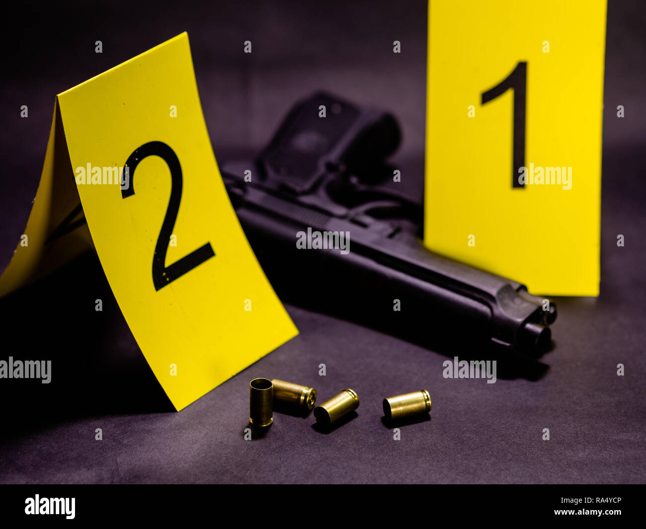 Bullets and gun next to markers at crime scene Stock Photo - Alamy