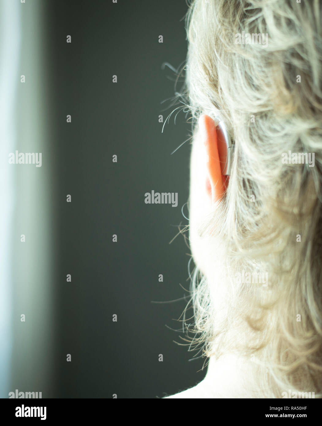 Deaf lady with modern technology digital hearing aid in her ear Stock ...