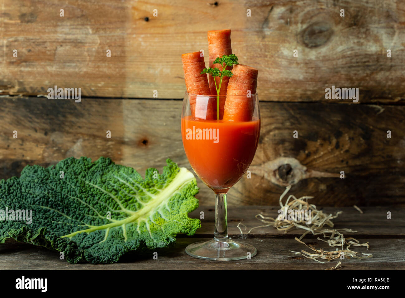 Healthy, full of vitamins, spring juice of fresh carrot and parsley in ...