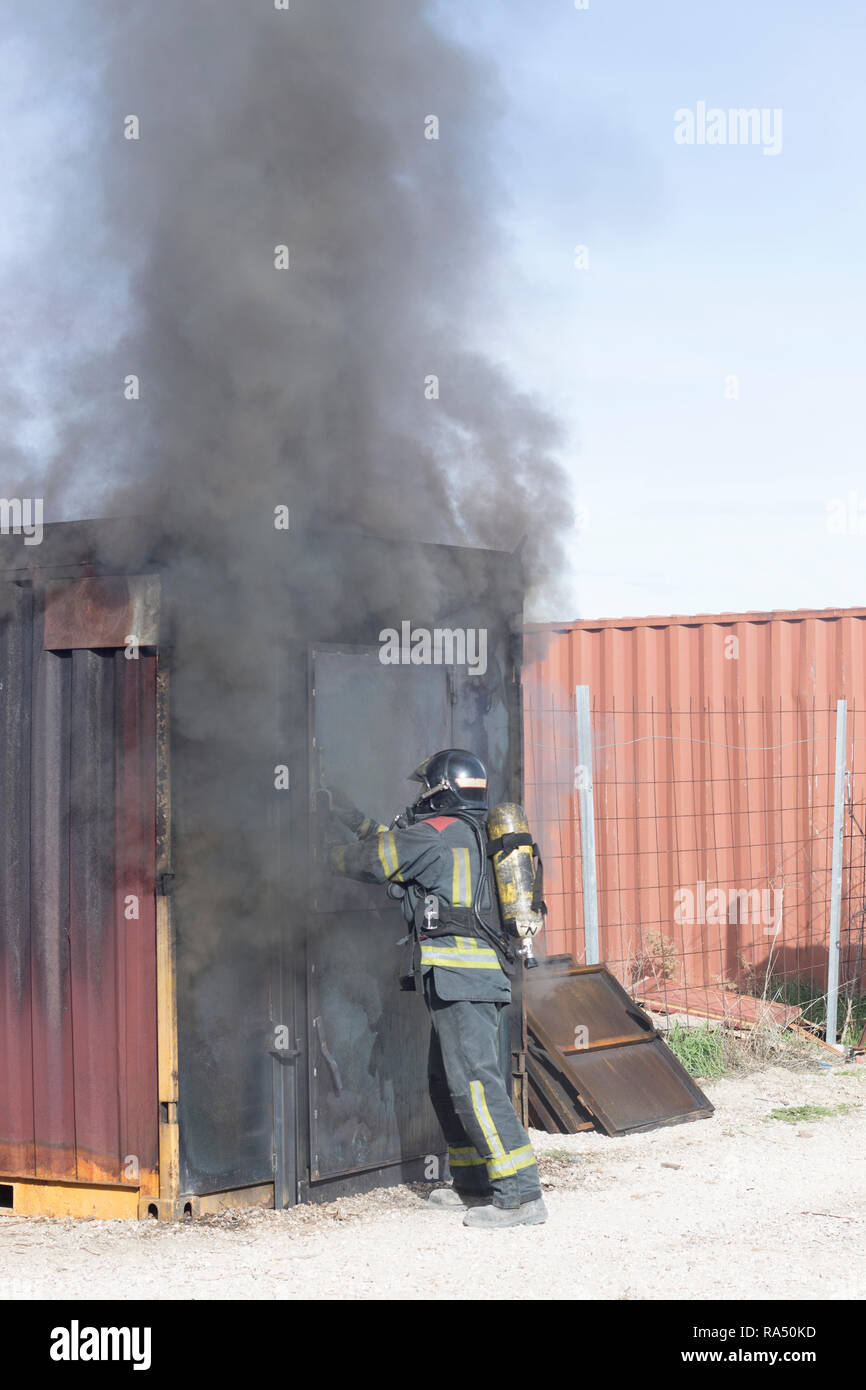 Firefighter putting out fire training station extinguisher backdraft ...