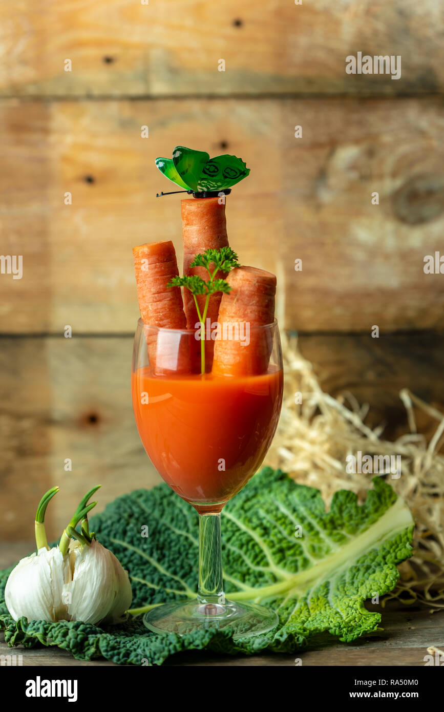 Healthy, full of vitamins, spring juice of fresh carrot and parsley in ...