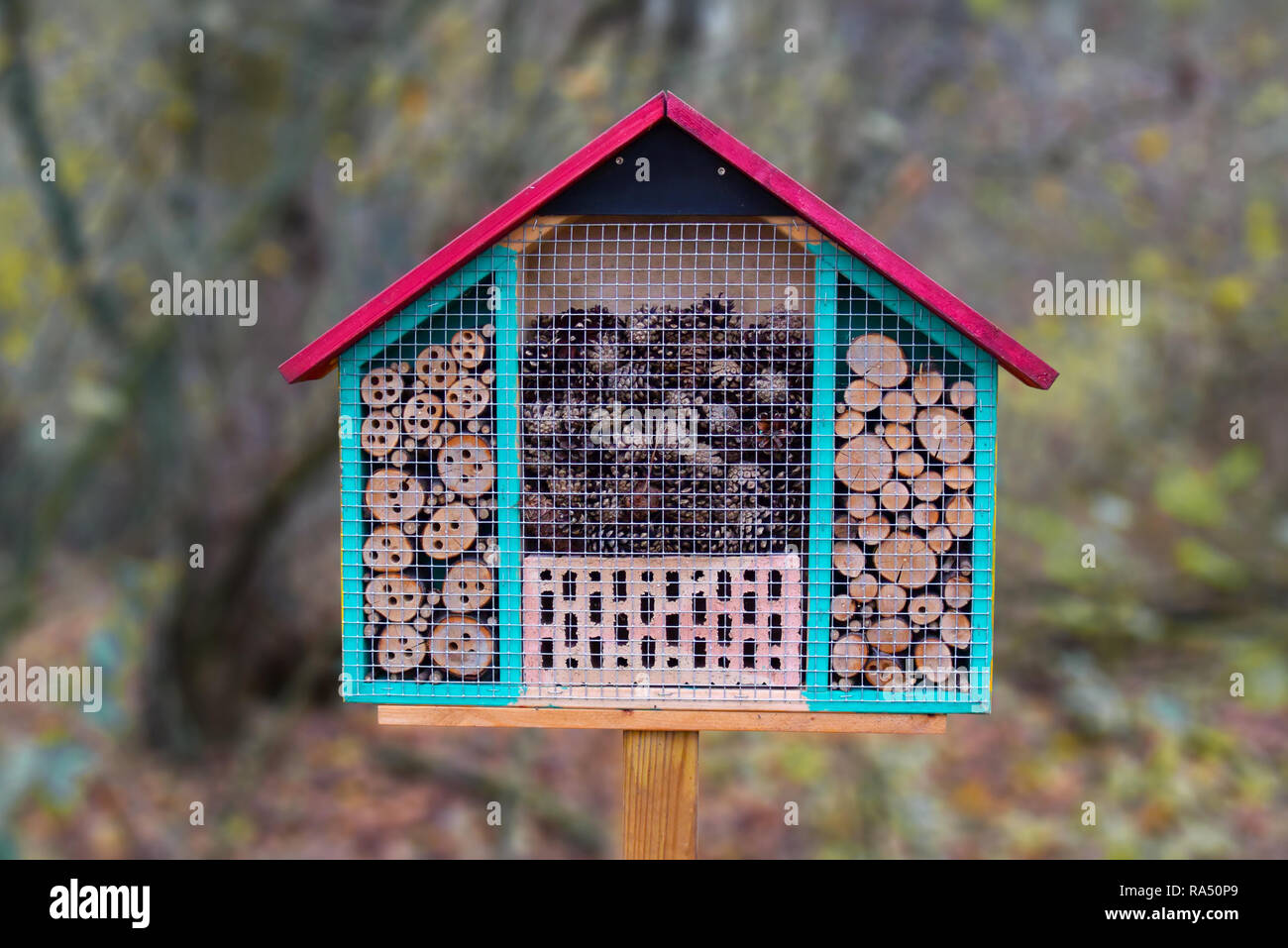 Close up of a colorful wood insect house hotel structure created to ...