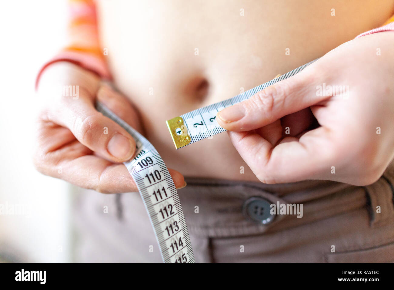 woman measures her abdomen with a measuring tape Stock Photo - Alamy
