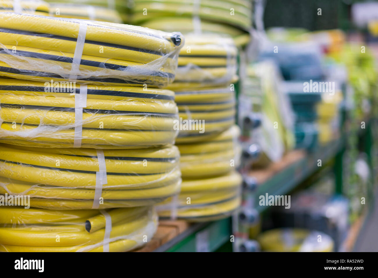 stacks of rolls yellow pvc plastic pipe on the counter in the store ...
