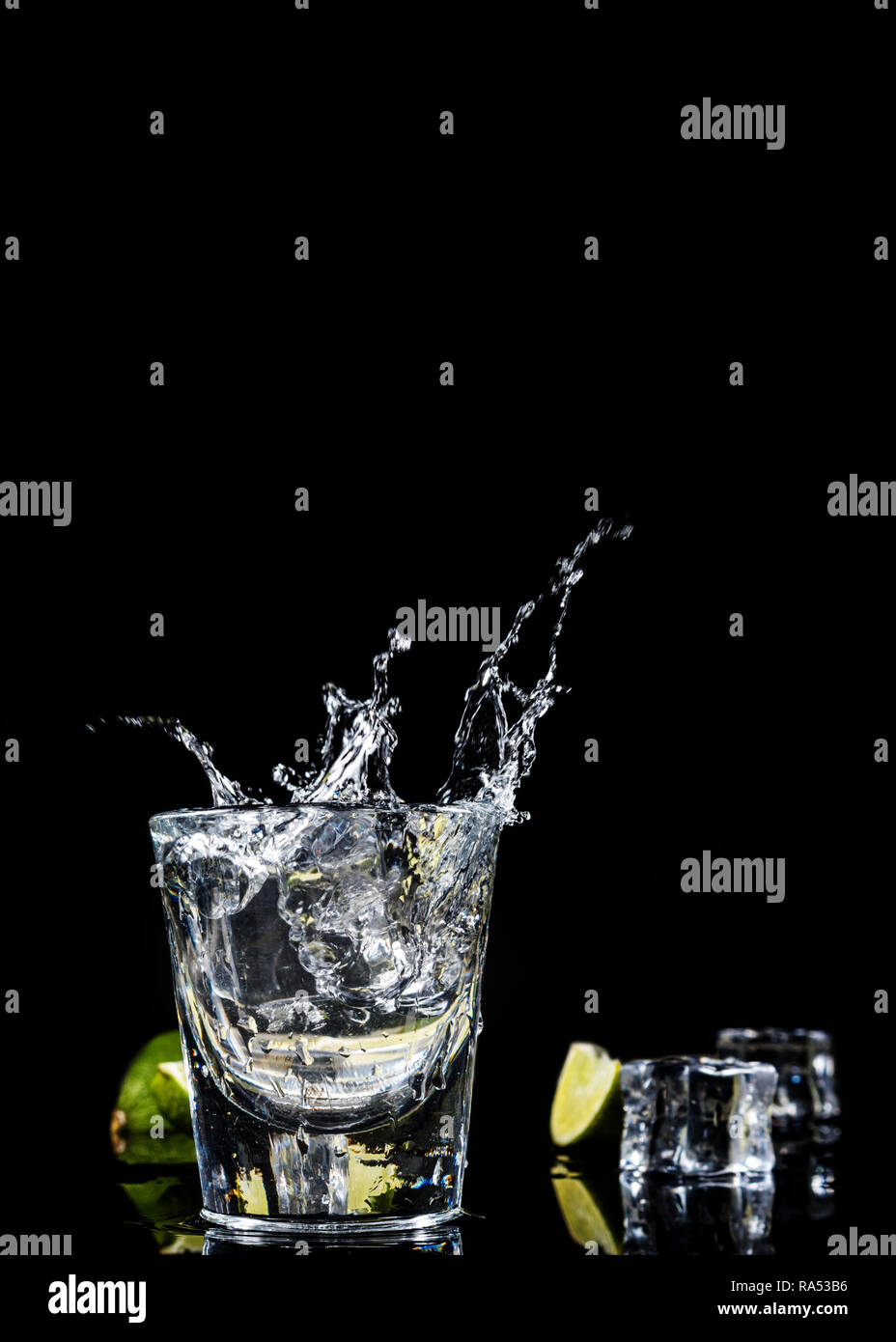 Mexican traditional Tequila splash ice cube on black background with ...