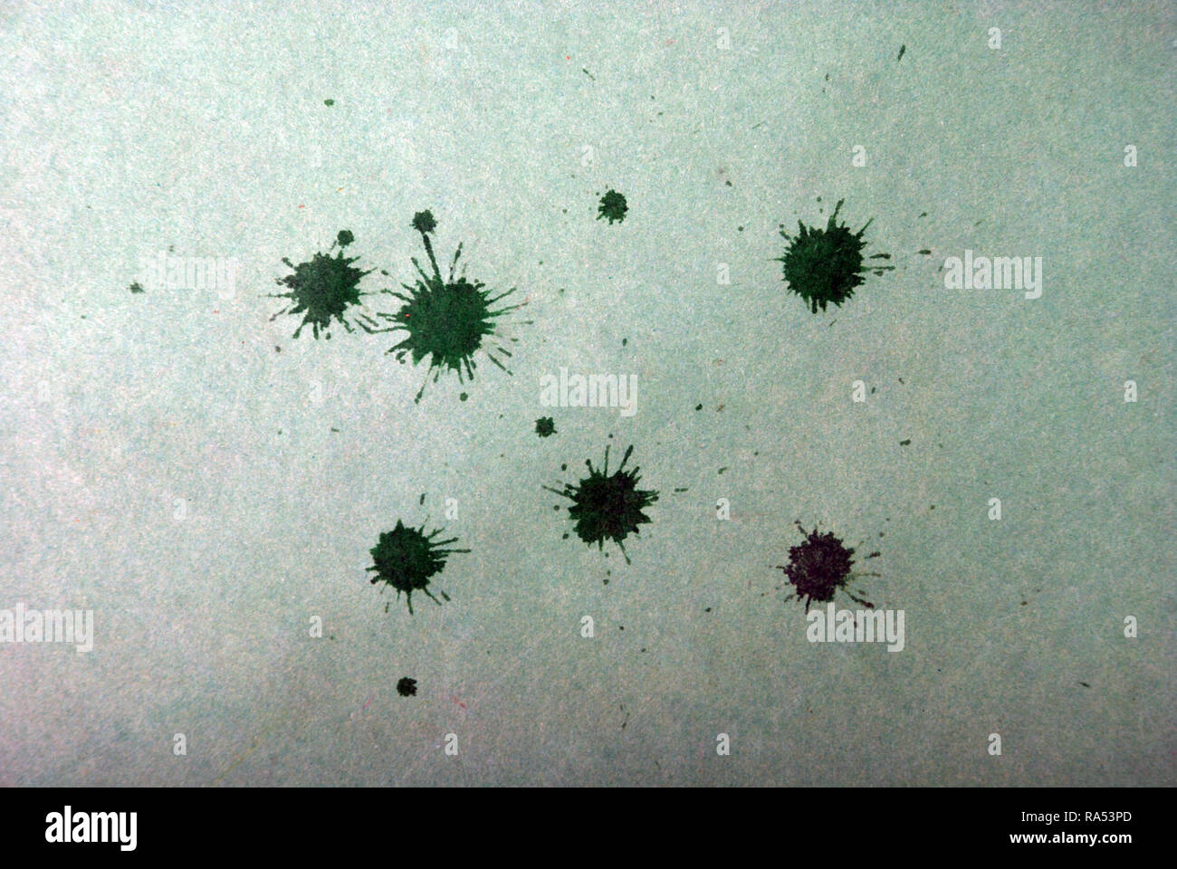 Green ink blots on a paper background close-up Stock Photo - Alamy