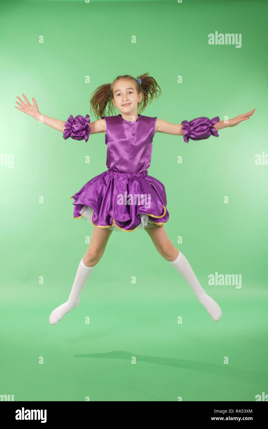 Pretty Girl Posing For The Camera In A Violet Short Dress Isolated On