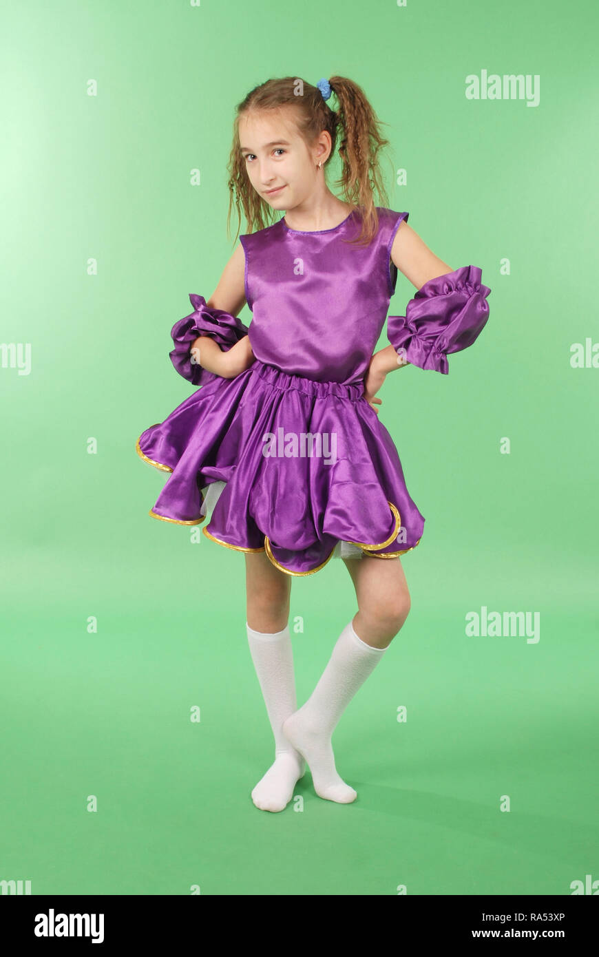 Pretty Girl Posing For The Camera In A Violet Short Dress Isolated On